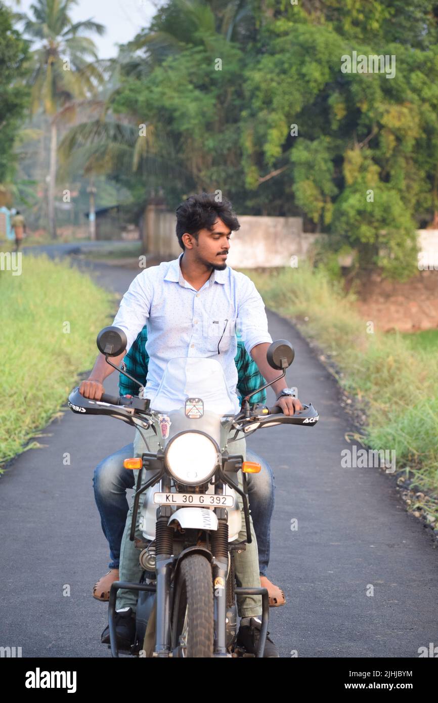 Two friends posing on a motorbike. Concept- travel and friendship Stock ...
