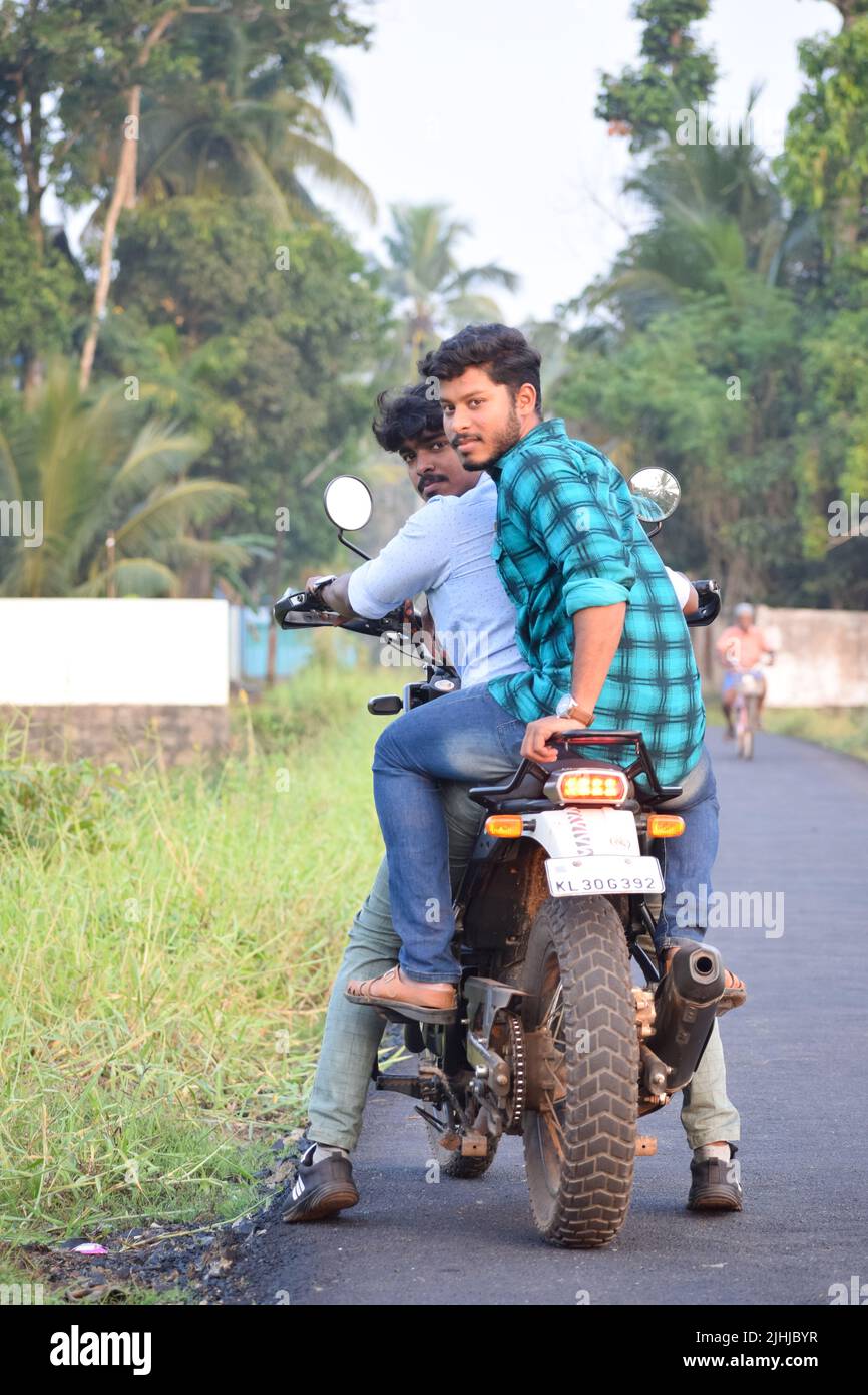 Two friends posing on a motorbike. Concept- travel and friendship Stock ...