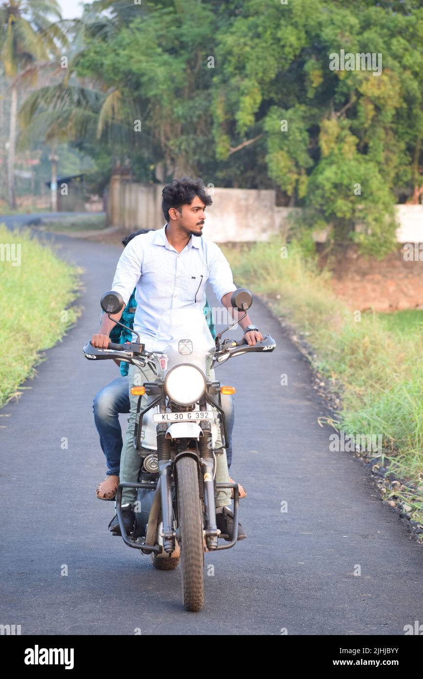 Two friends posing on a motorbike. Concept- travel and friendship Stock ...