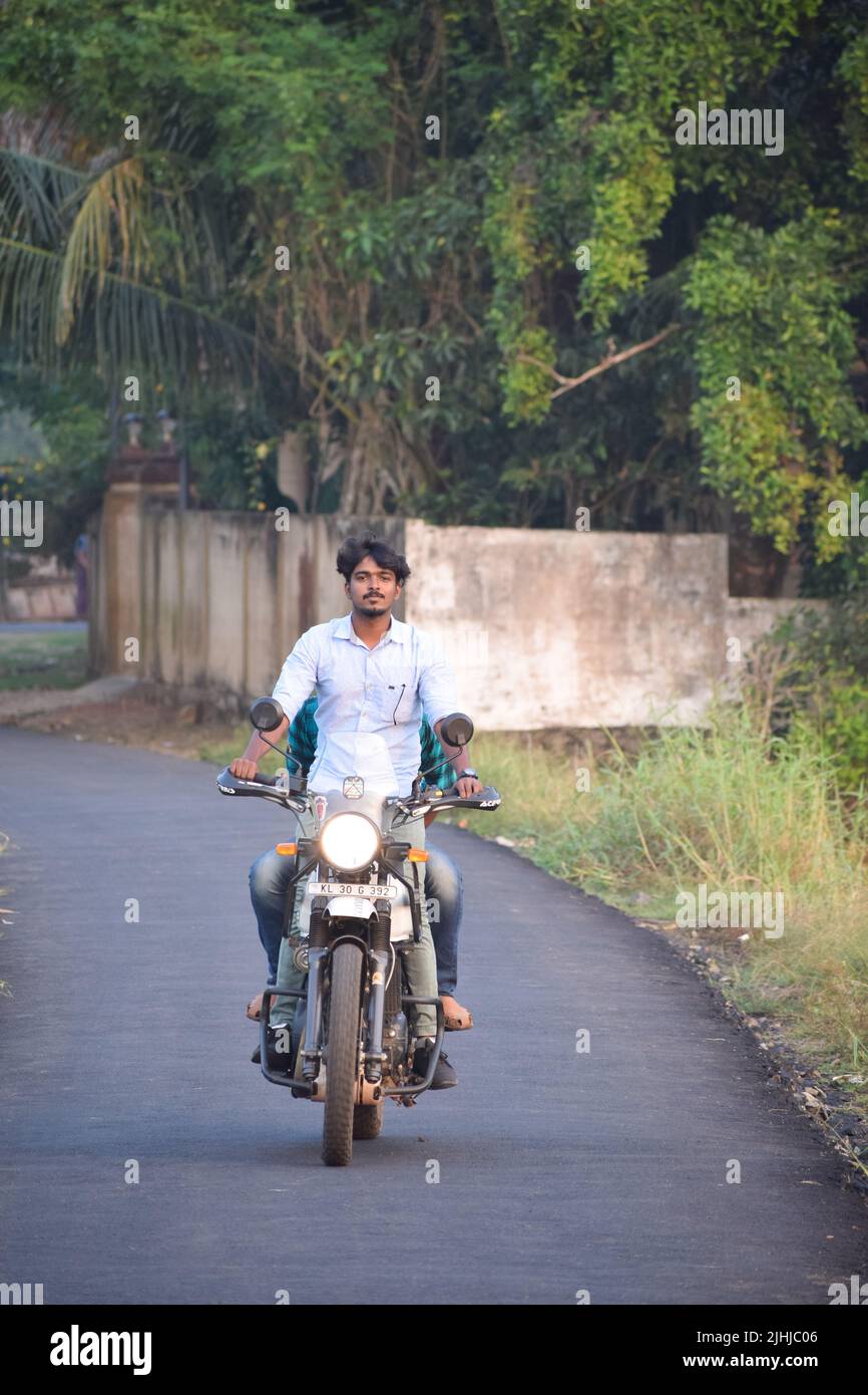 Two friends posing on a motorbike. Concept- travel and friendship Stock ...