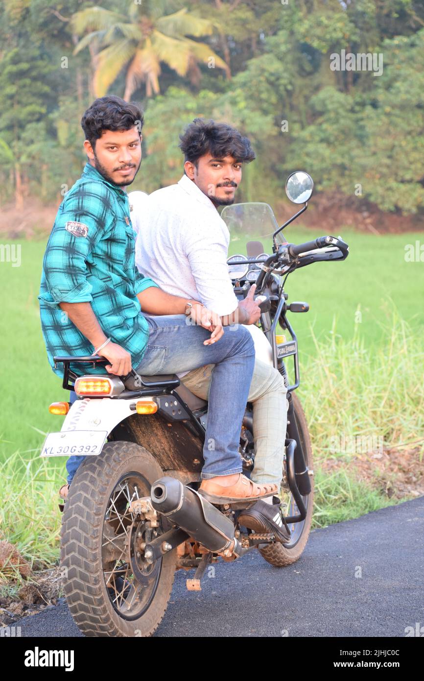 Two friends posing on a motorbike. Concept- travel and friendship Stock ...