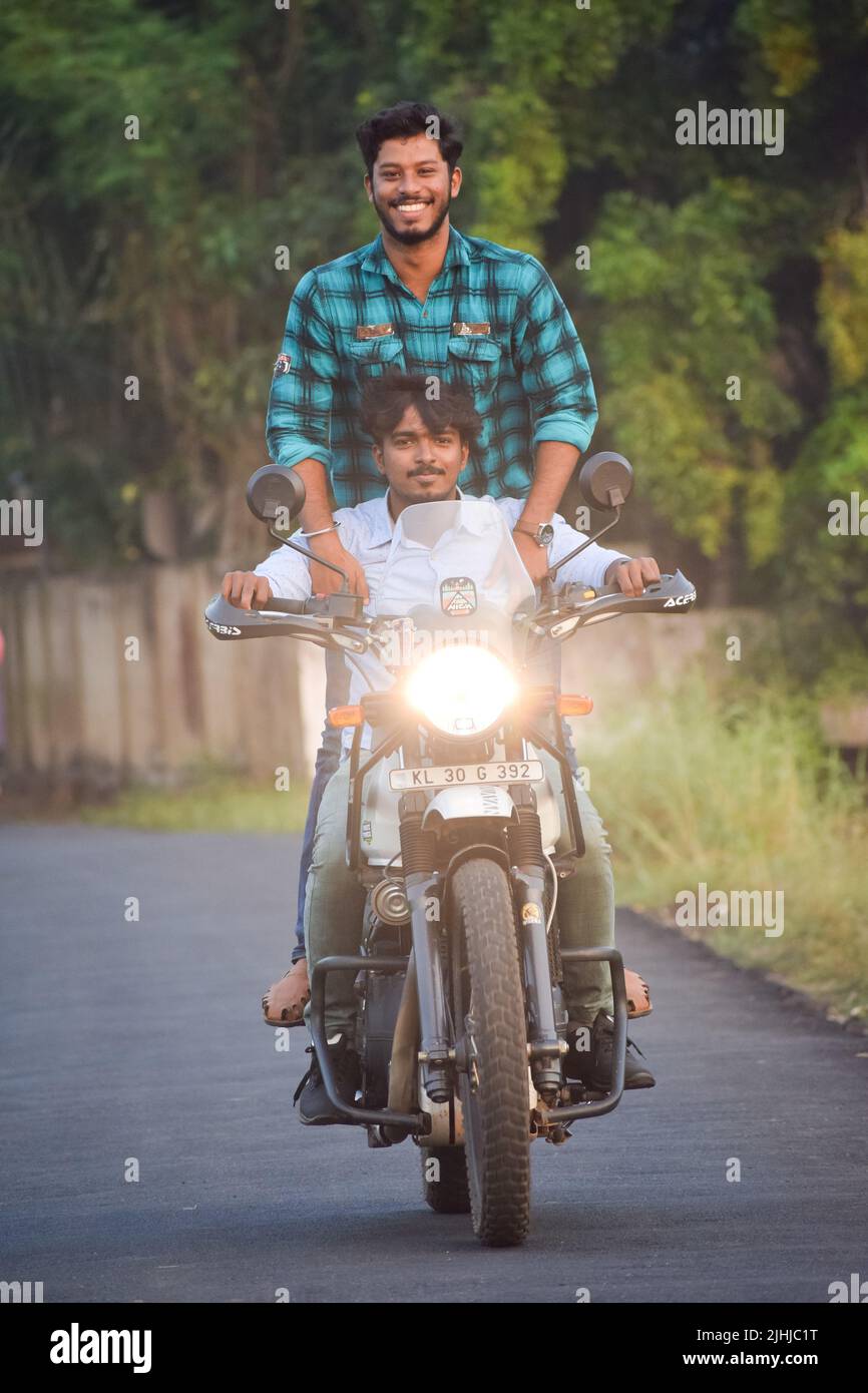 Two friends posing on a motorbike. Concept- travel and friendship Stock ...