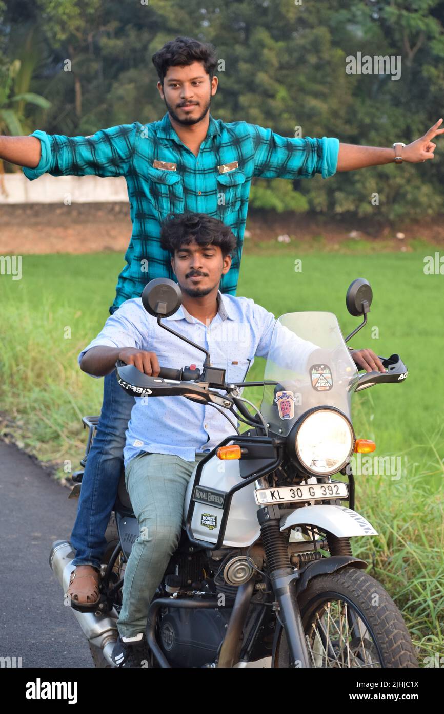 Two friends posing on a motorbike. Concept- travel and friendship Stock ...
