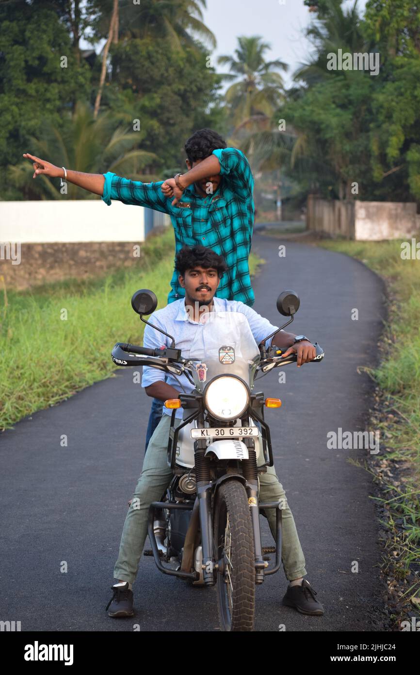 Two friends posing on a motorbike. Concept- travel and friendship Stock ...
