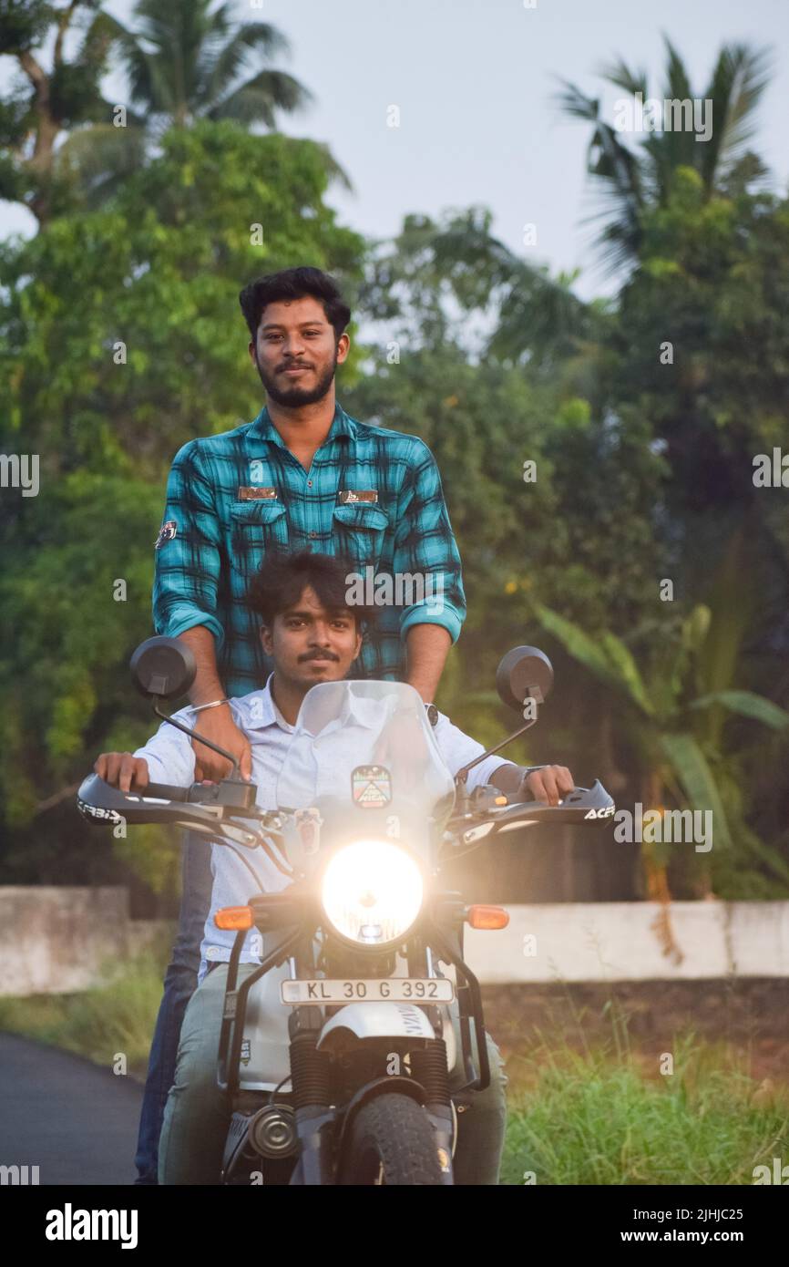 Two friends posing on a motorbike. Concept- travel and friendship Stock ...