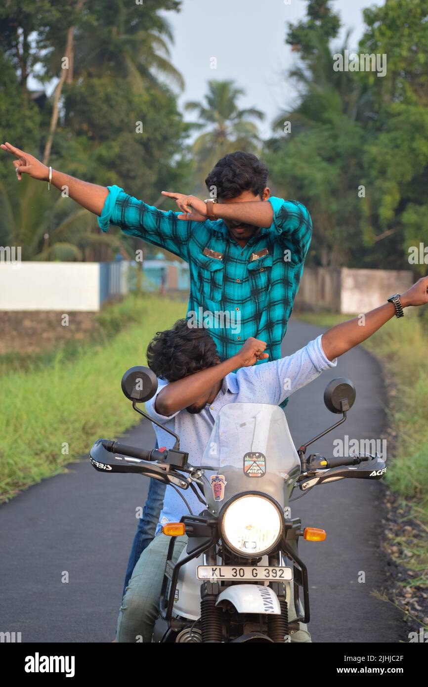 Two friends posing on a motorbike. Concept- travel and friendship Stock ...