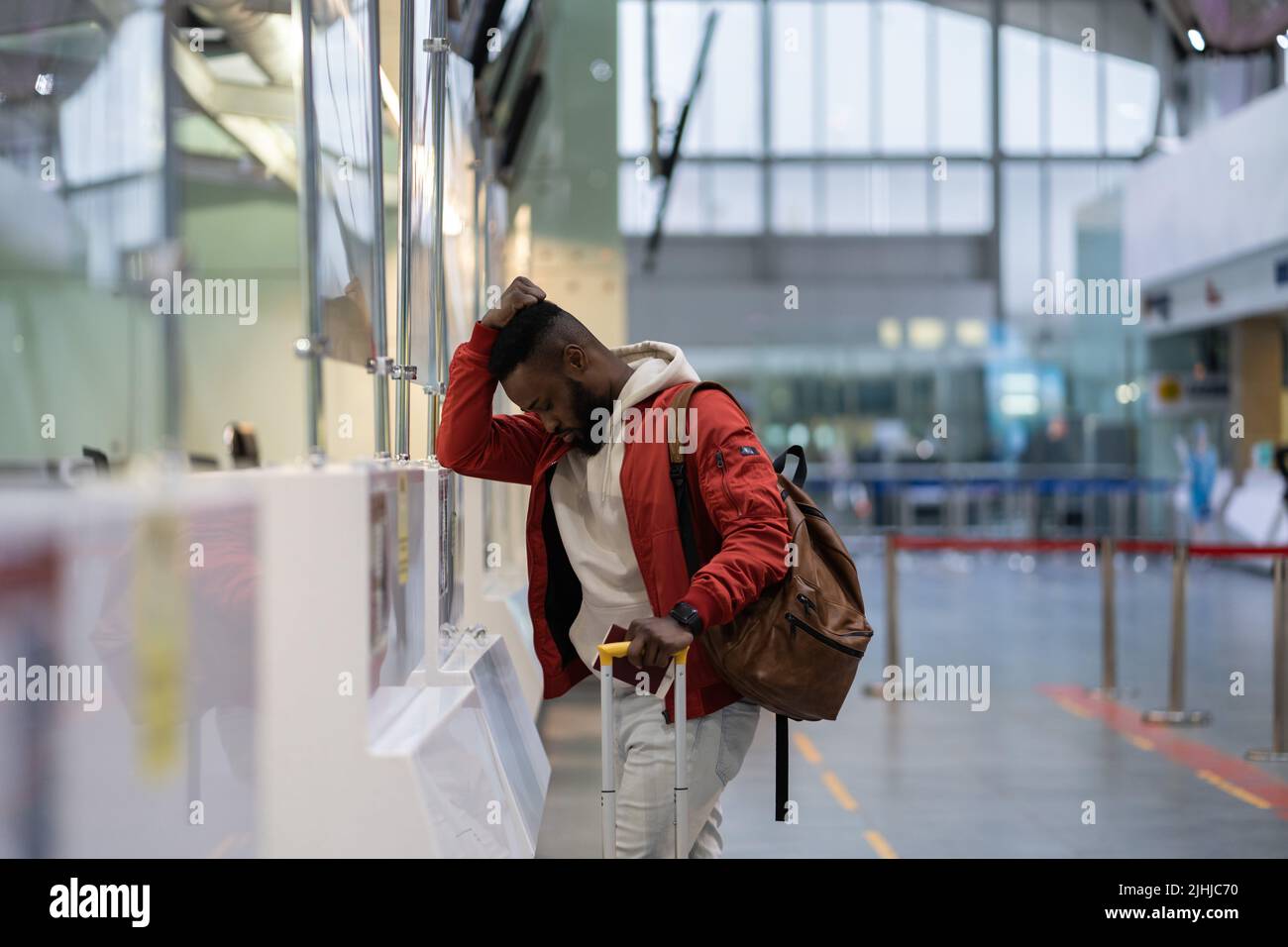 Frustrated sad young African man passenger having problems with check ...