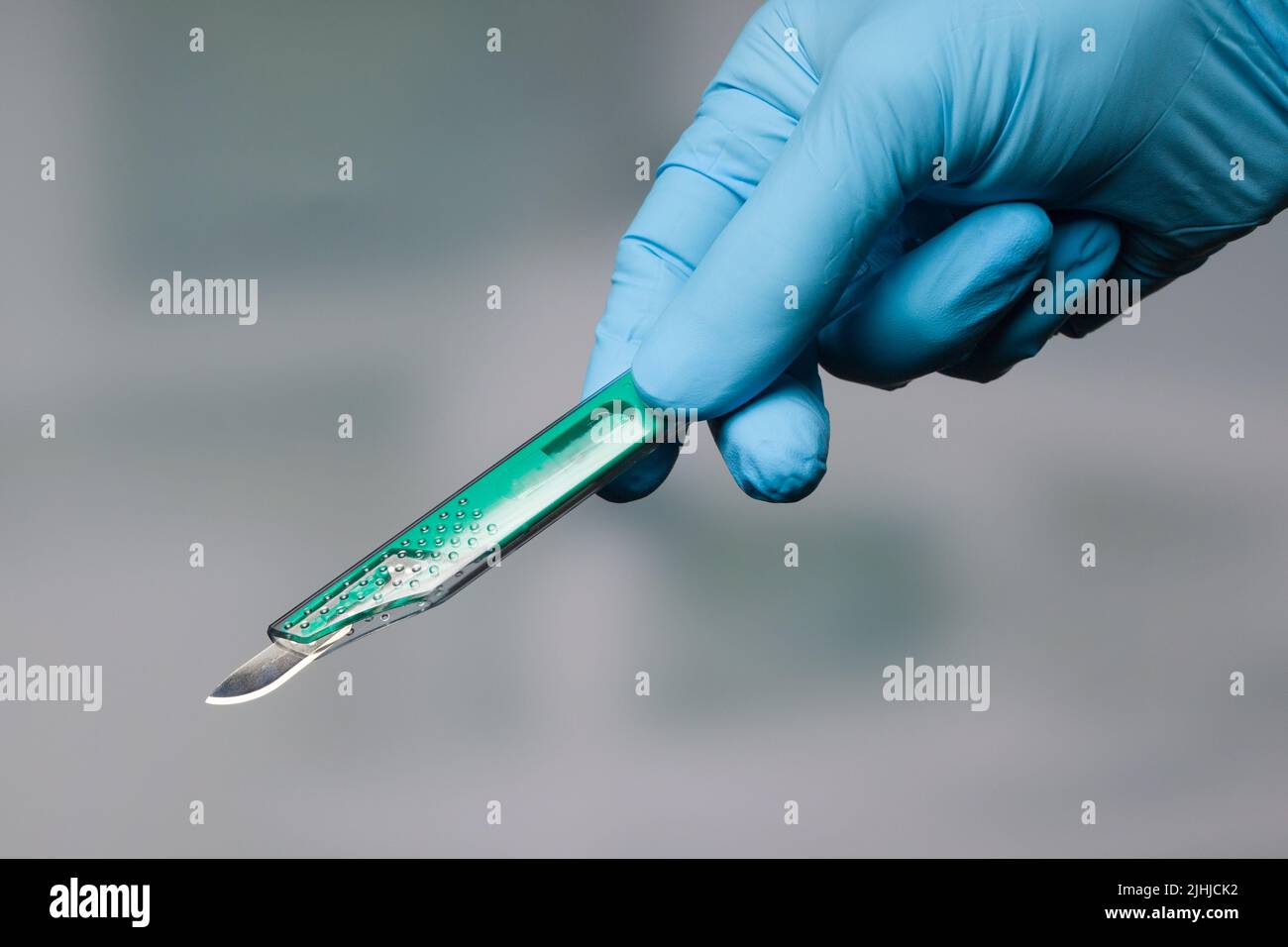 close-up of doctor's hand with a new disposable scalpel ready for a cut ...