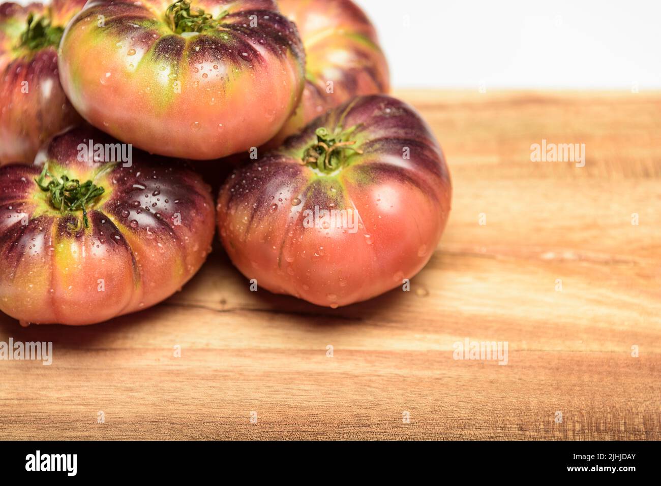 Still life tiger tomatoes dark background Stock Photo - Alamy
