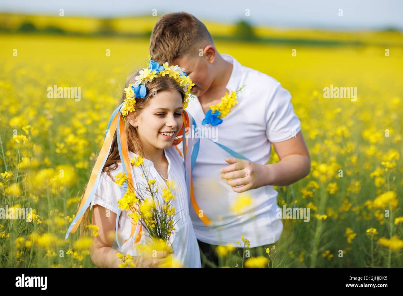 Front view of happy carefree native children: older teenage brother and ...