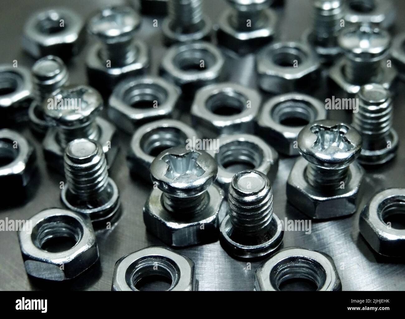 Screw bolts and hex nuts closeup texture background Stock Photo - Alamy