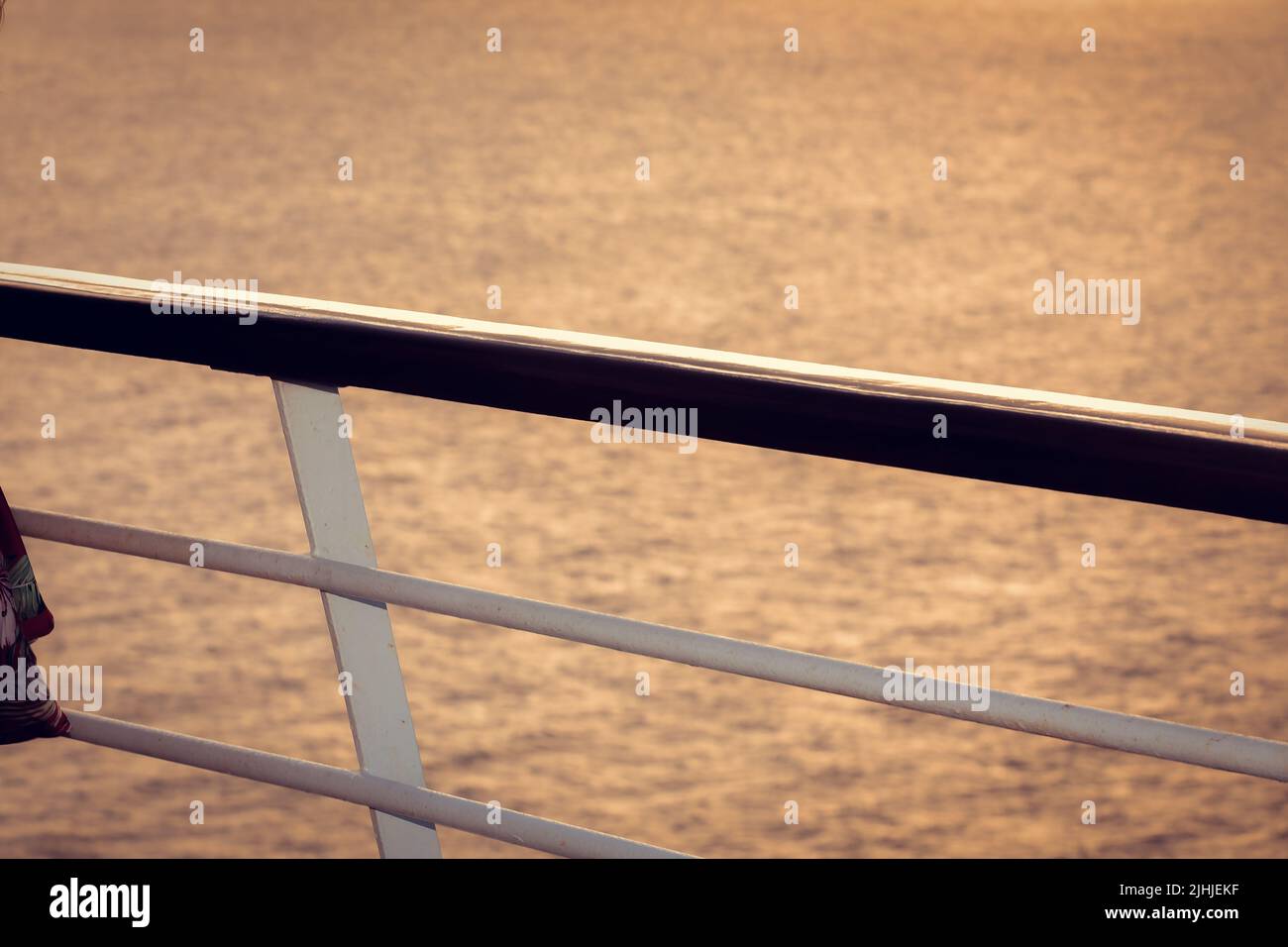 Wooden deck and railing from cruise ship. Beautiful sunset and ocean ...
