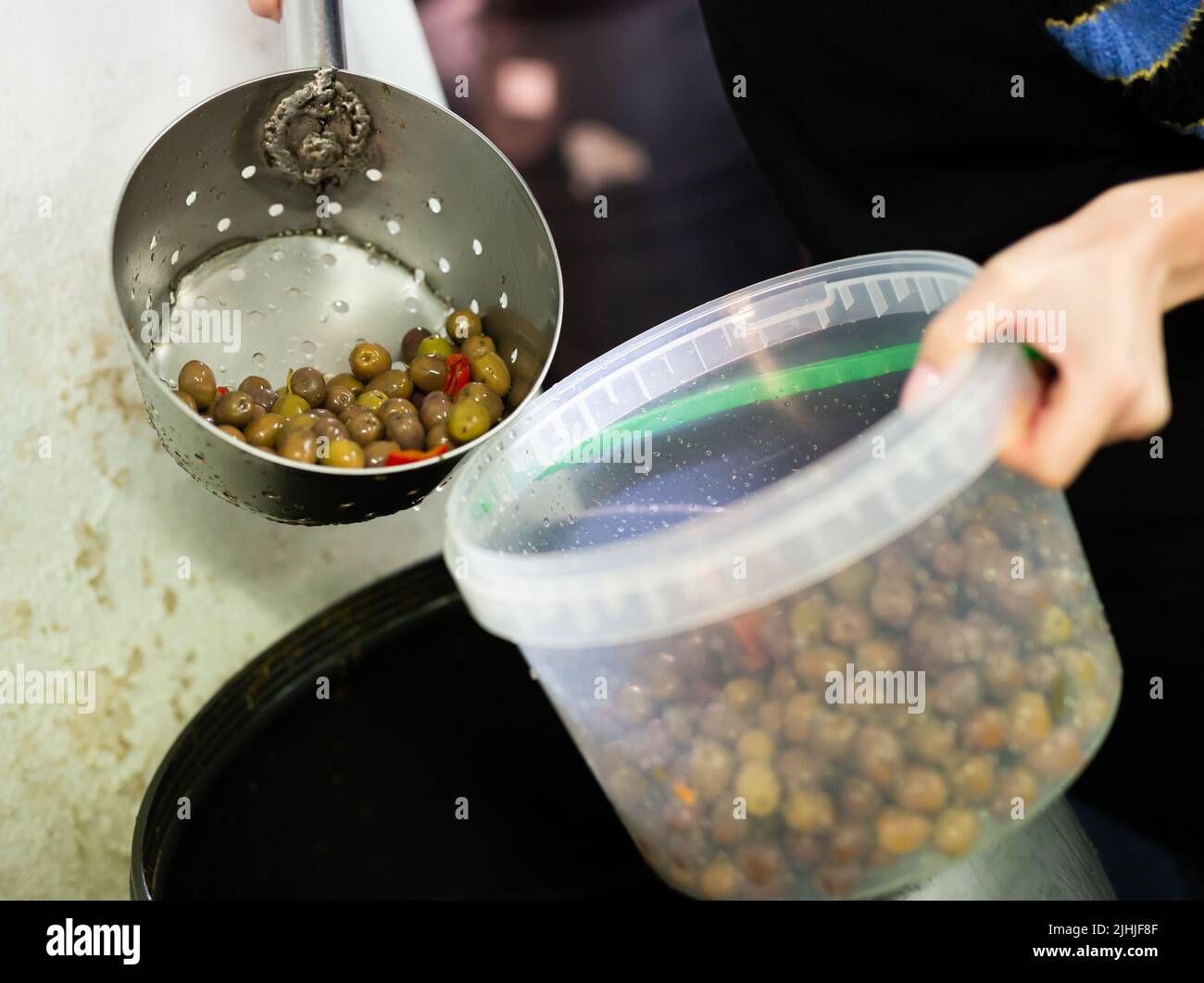 Packing olives in plastic containers Stock Photo - Alamy