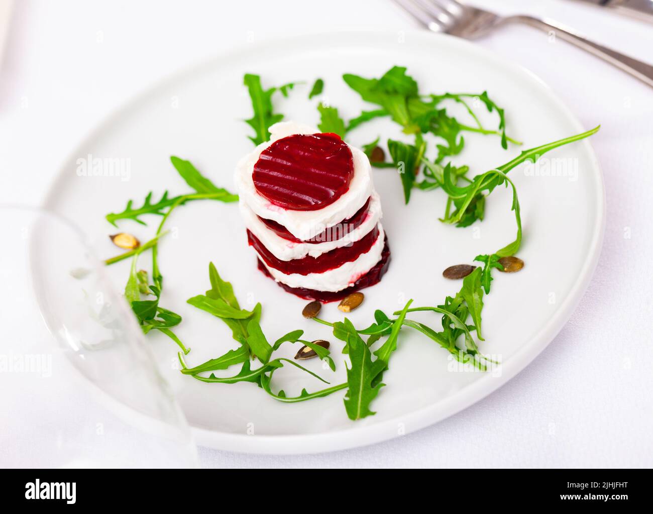 Fresh beetroot and goat cheese salad served on plate Stock Photo - Alamy