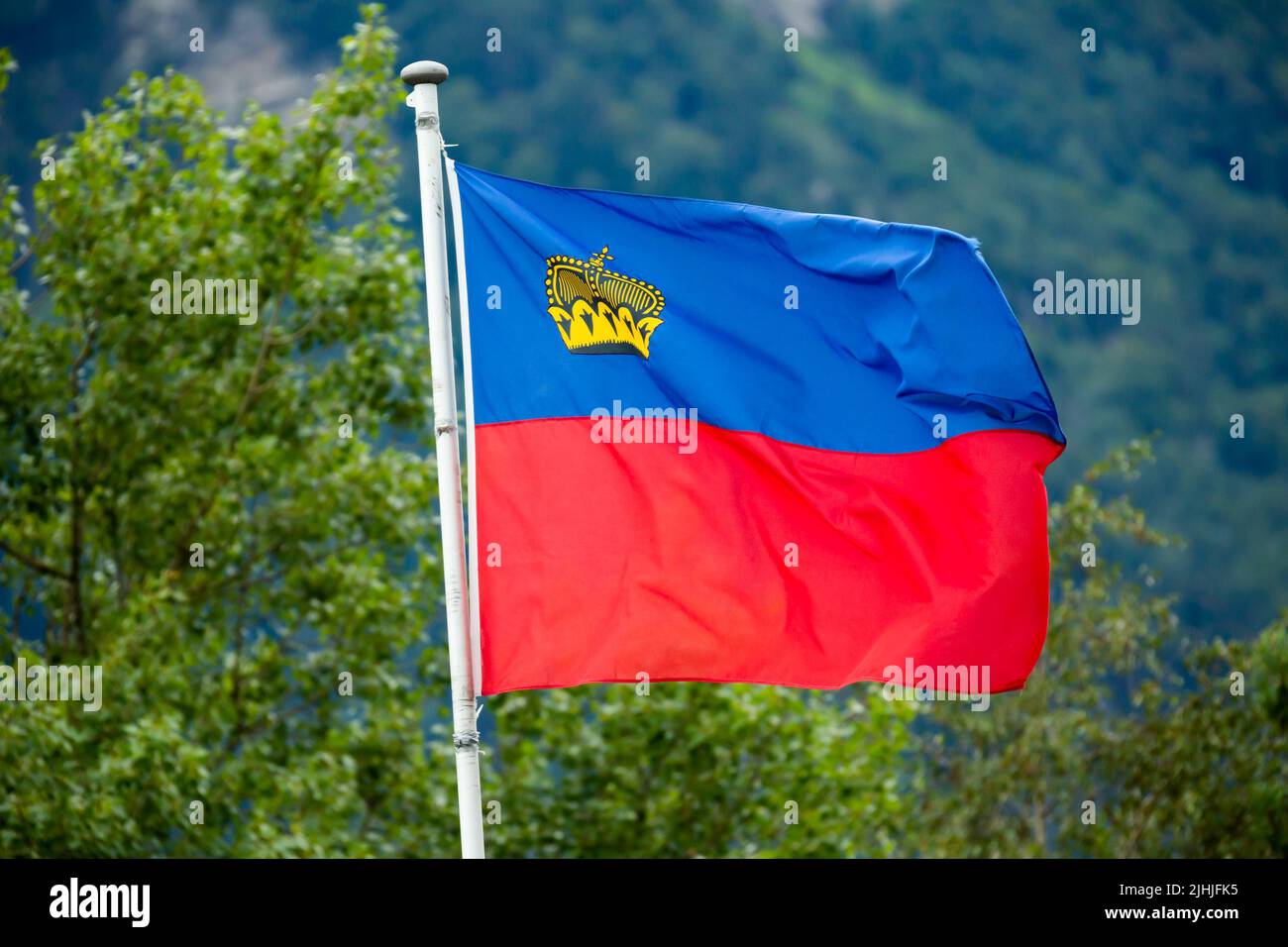 Flag of Liechtenstein on mountains background on summer Stock Photo - Alamy