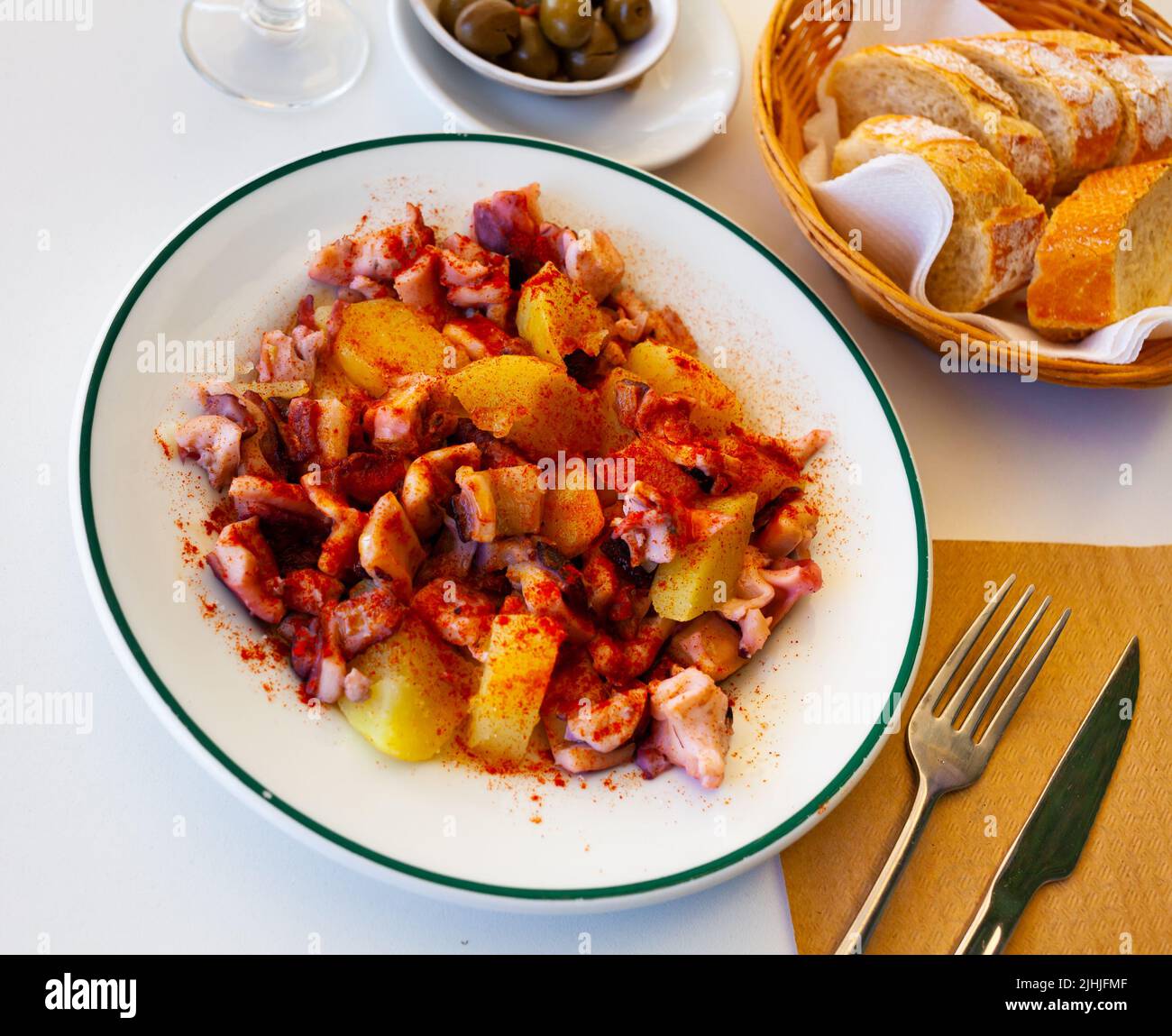Galician-style octopus served on plate Stock Photo - Alamy