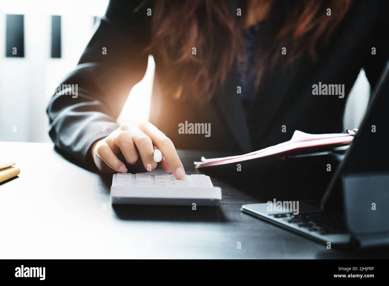 Business woman using calculator to review balance sheet annual using ...