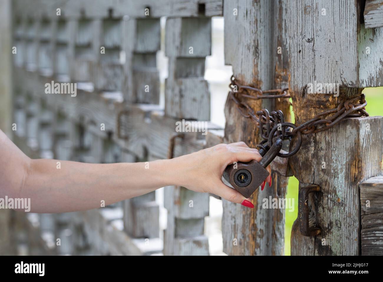 hand pulls the lock on which the gate is closed. High quality photo ...