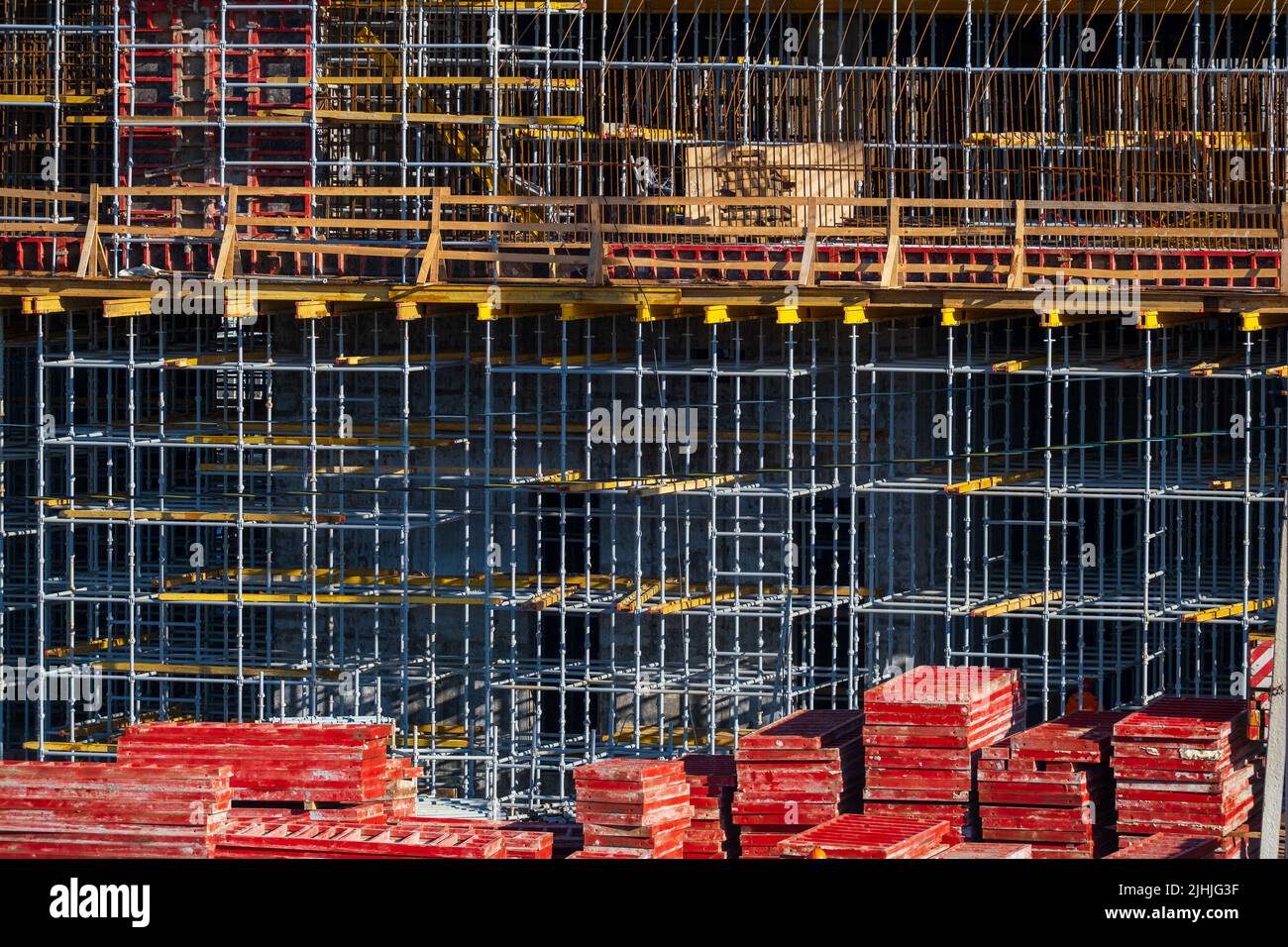 Red blocks outside unfinished building Stock Photo - Alamy