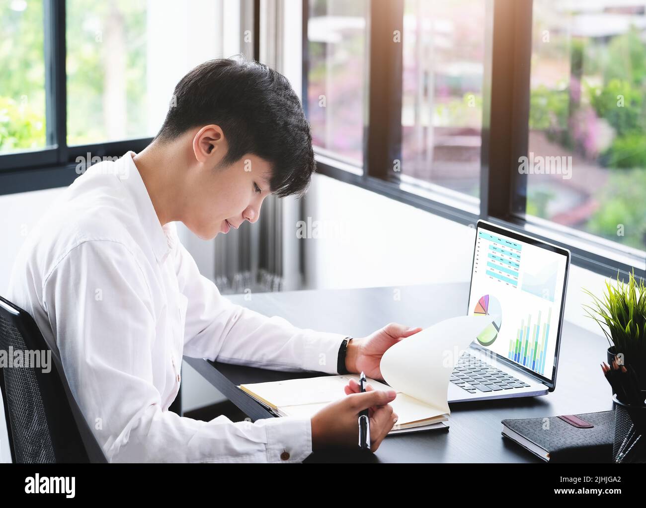 Business man using computer to review balance sheet annual using ...