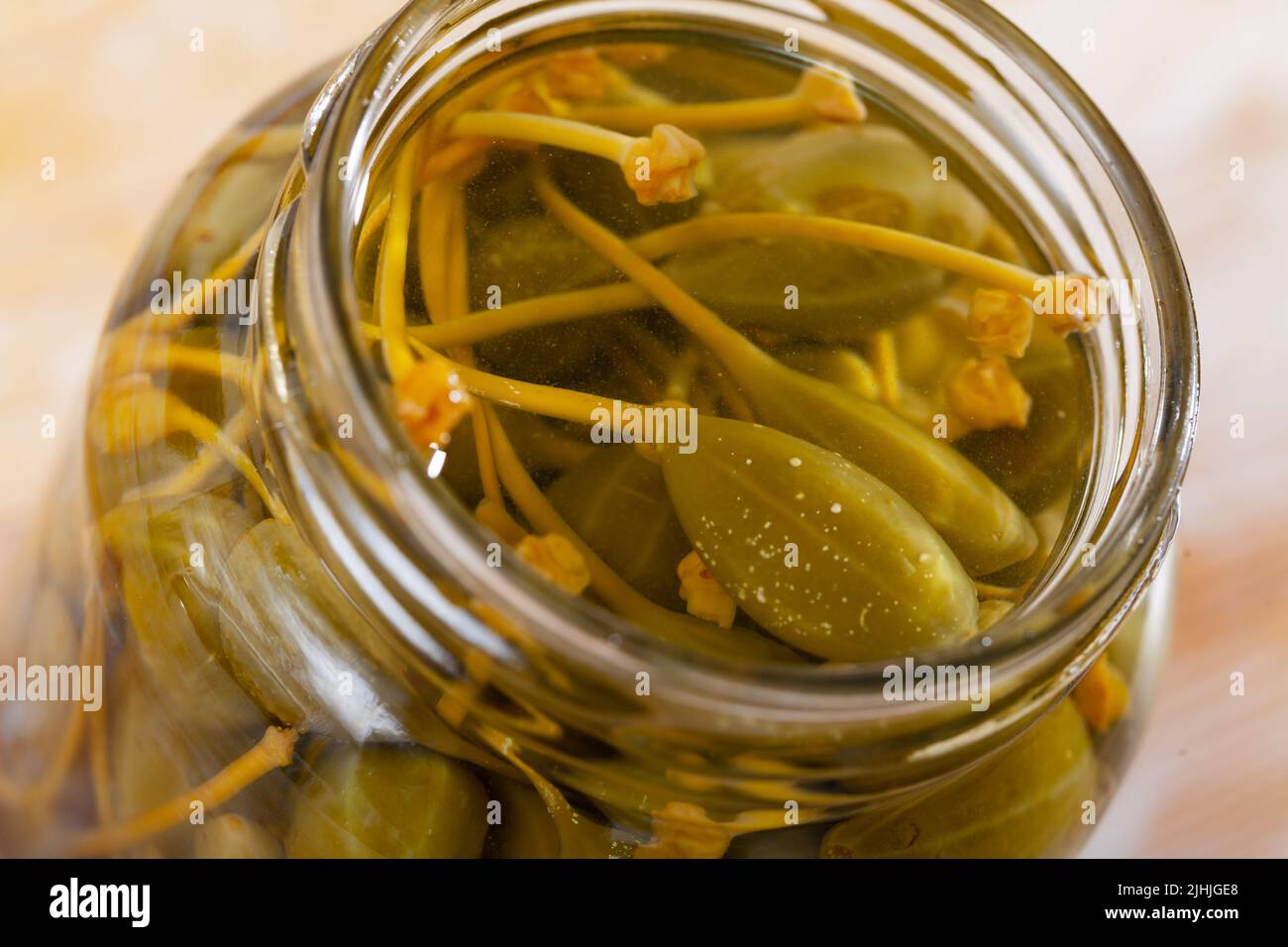 Glass jar with pickled green capers Stock Photo - Alamy