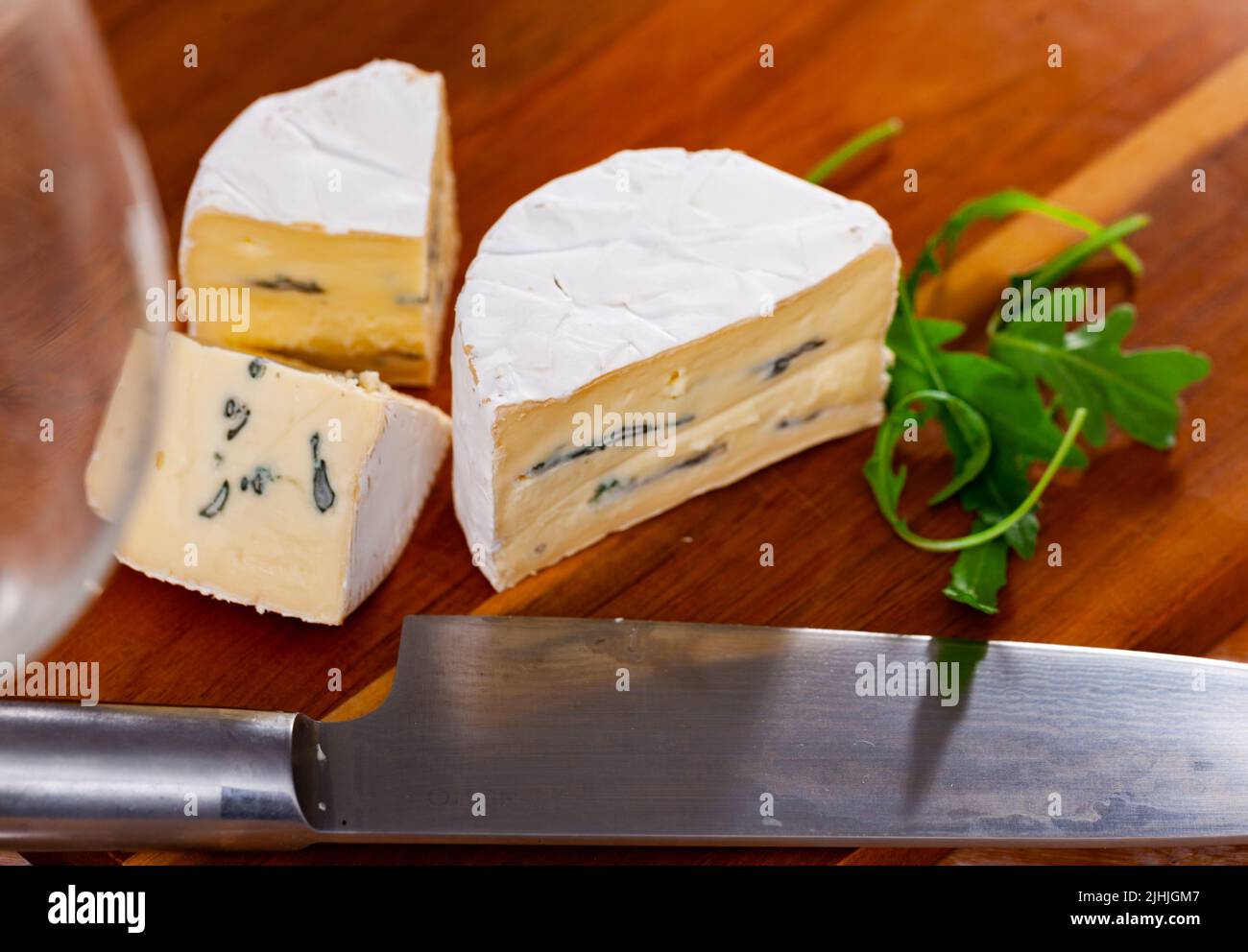 Whole wheel of piquant creamy blue cheese on cutting board Stock Photo ...