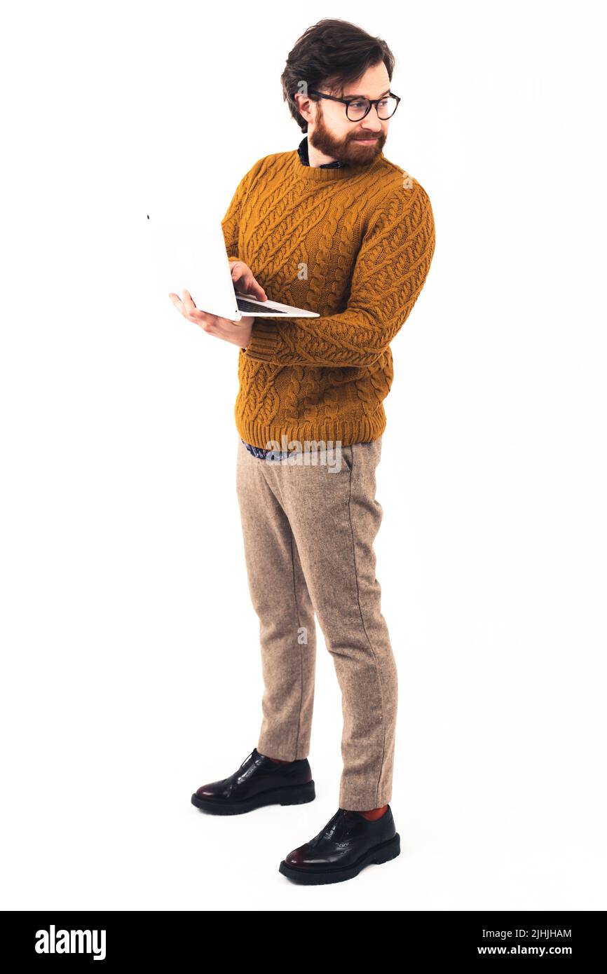 Stylish man looking off his computer - full body shot isolated on white ...