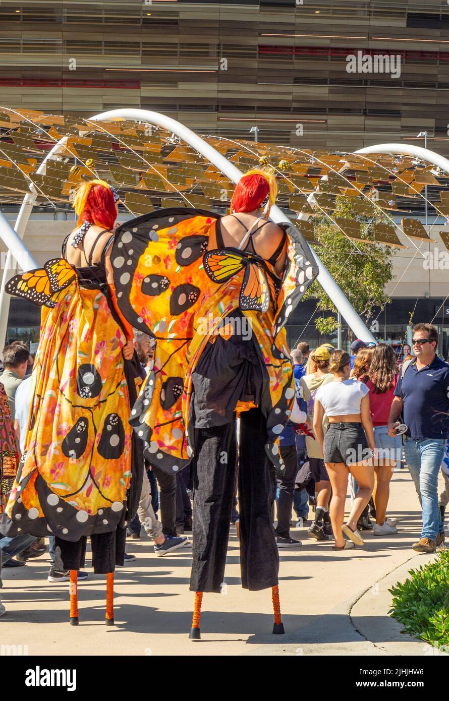Two women on stilts in costume dressed as butterflies at AFL Grand ...