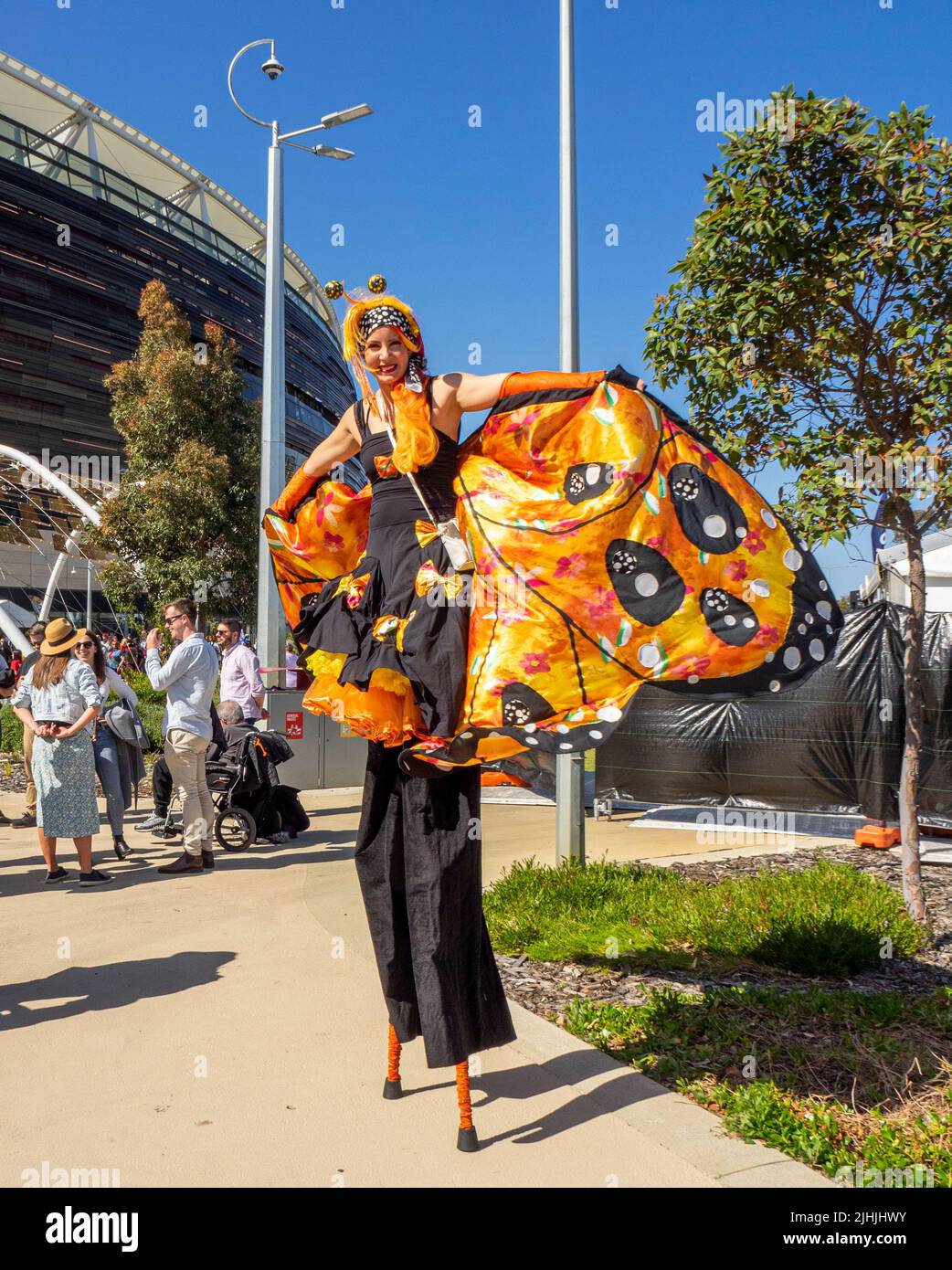 Womanon stilts in costume dressed as butterfly at AFL Grand Final 2021 ...