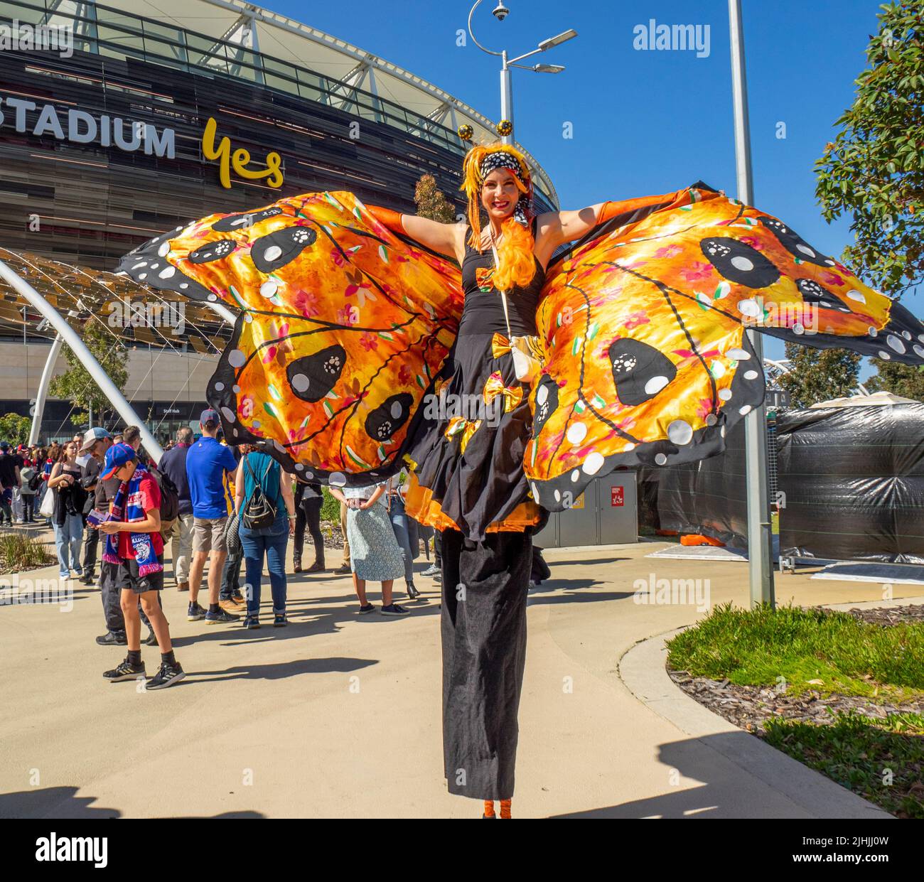 Womanon stilts in costume dressed as butterfly at AFL Grand Final 2021 ...