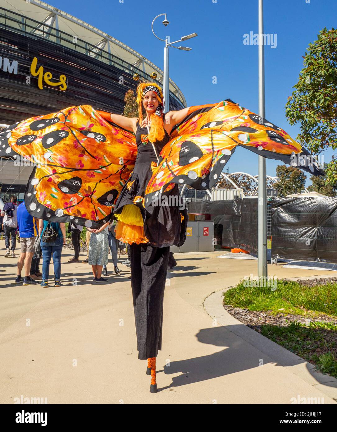 Womanon stilts in costume dressed as butterfly at AFL Grand Final 2021 ...