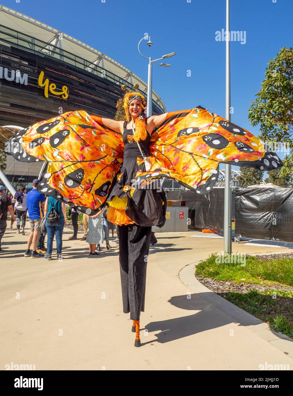 Womanon stilts in costume dressed as butterfly at AFL Grand Final 2021 ...