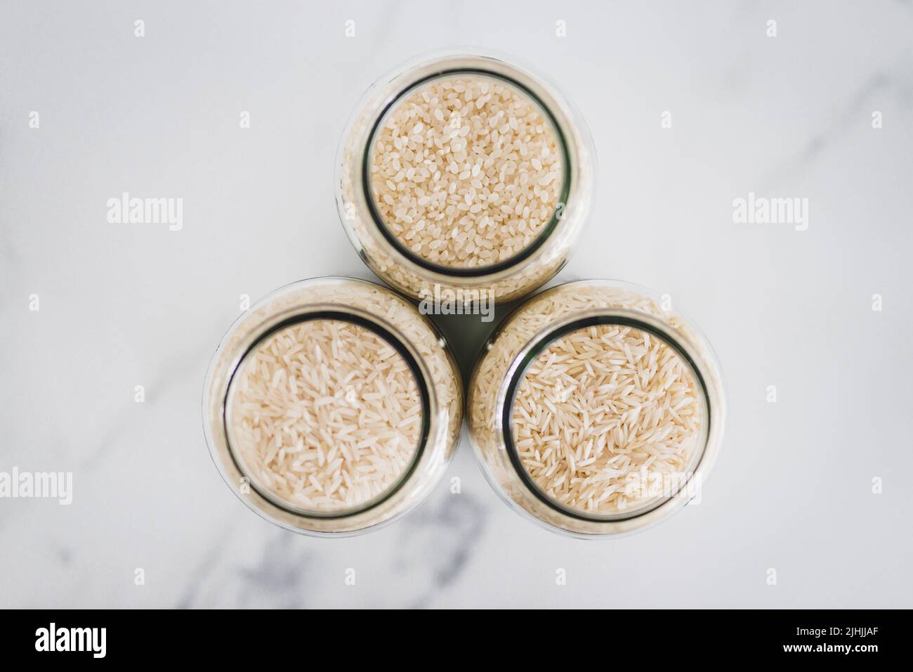 glass jar with white rice of different varieties including jasmine ...