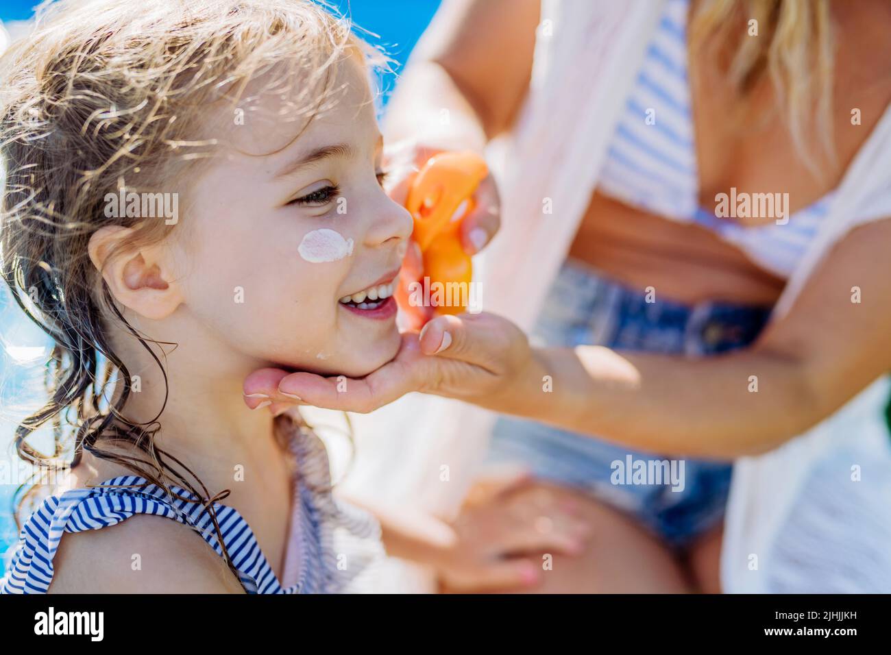 Woman applying sunscreen to face hi-res stock photography and images ...