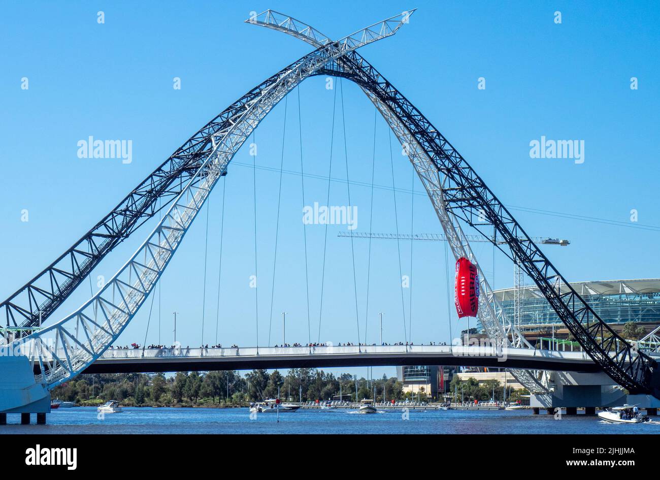 Spectators walking across Matagarup Bridge with a suspended inflatable ...