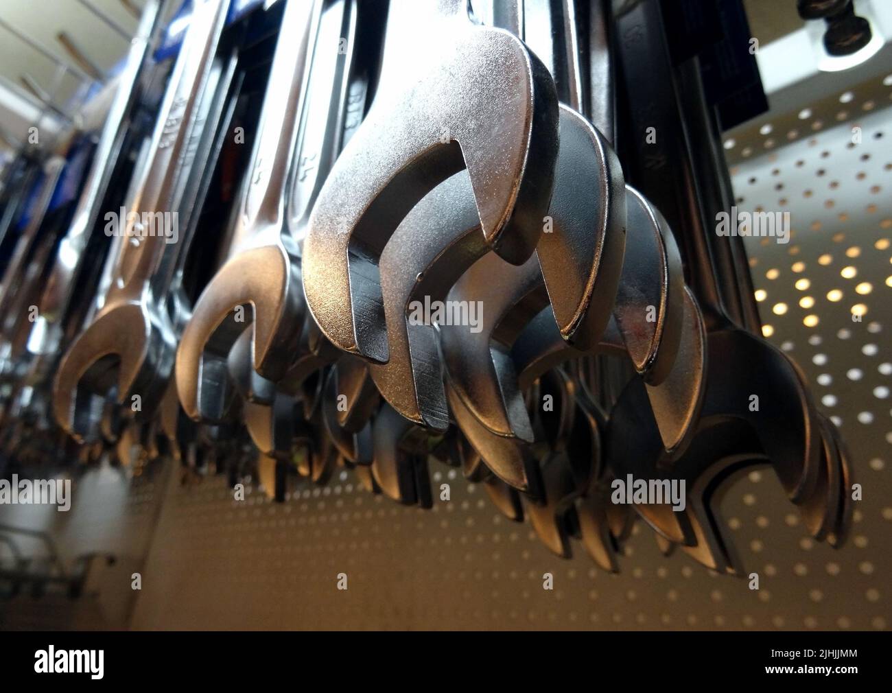 Fixing head of gear wrenches on the showcase in tools shop closeup ...