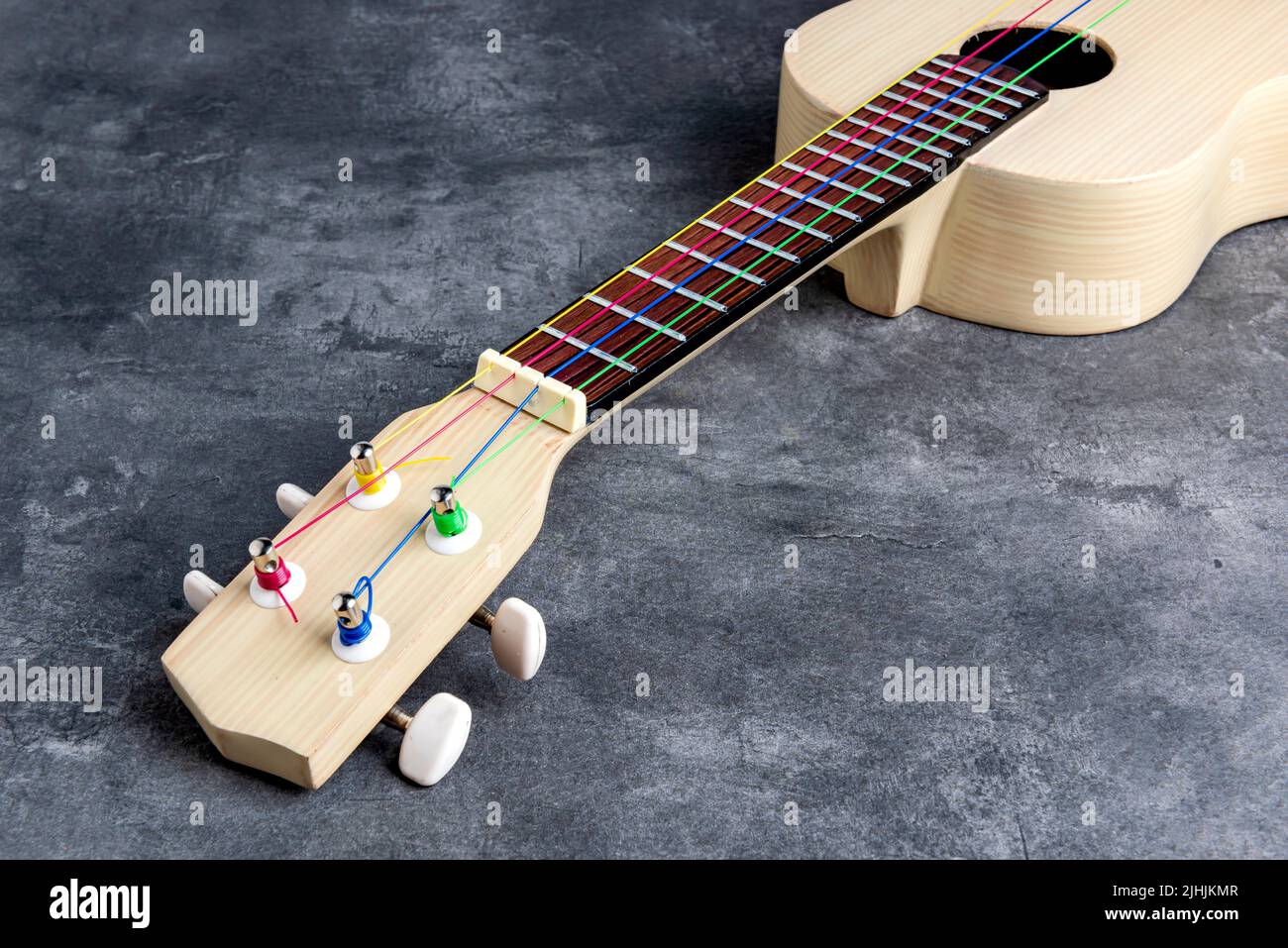 Ukulele guitar with black background Stock Photo - Alamy