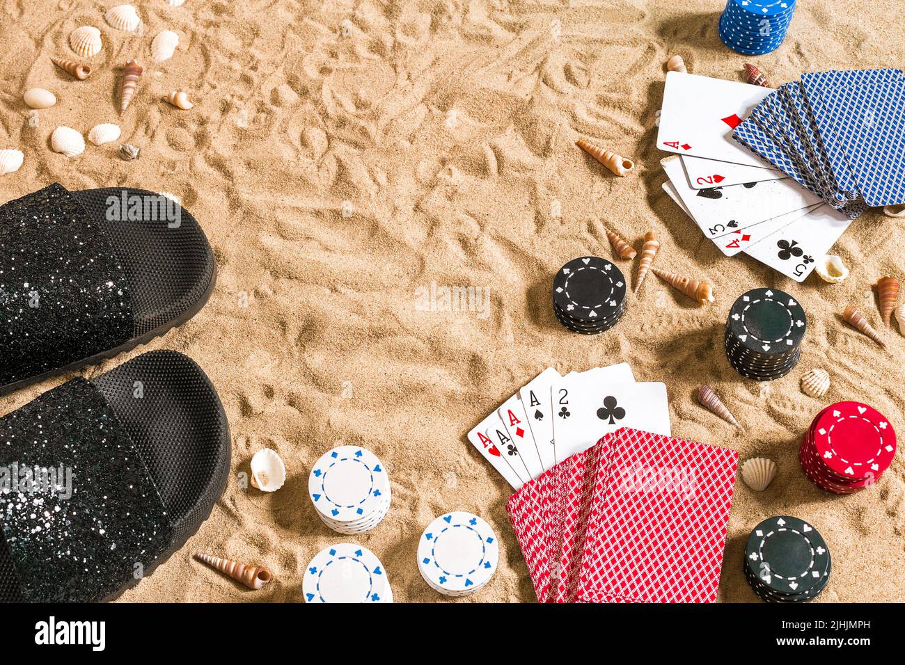 Beachpoker. Chips and cards on the sand. Around the seashells and flip ...