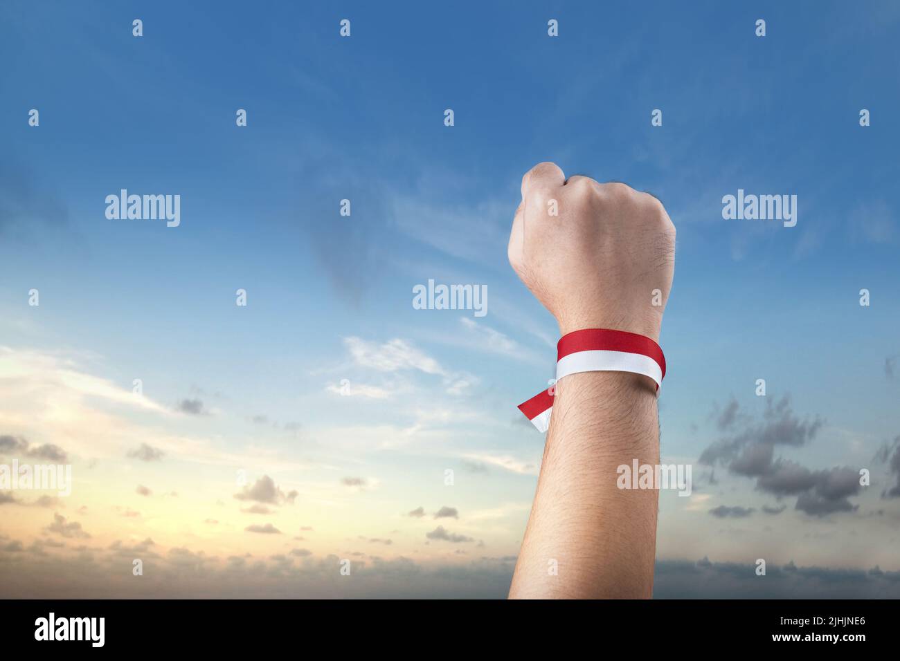 Human hand showing ribbon with the red and white color of the ...