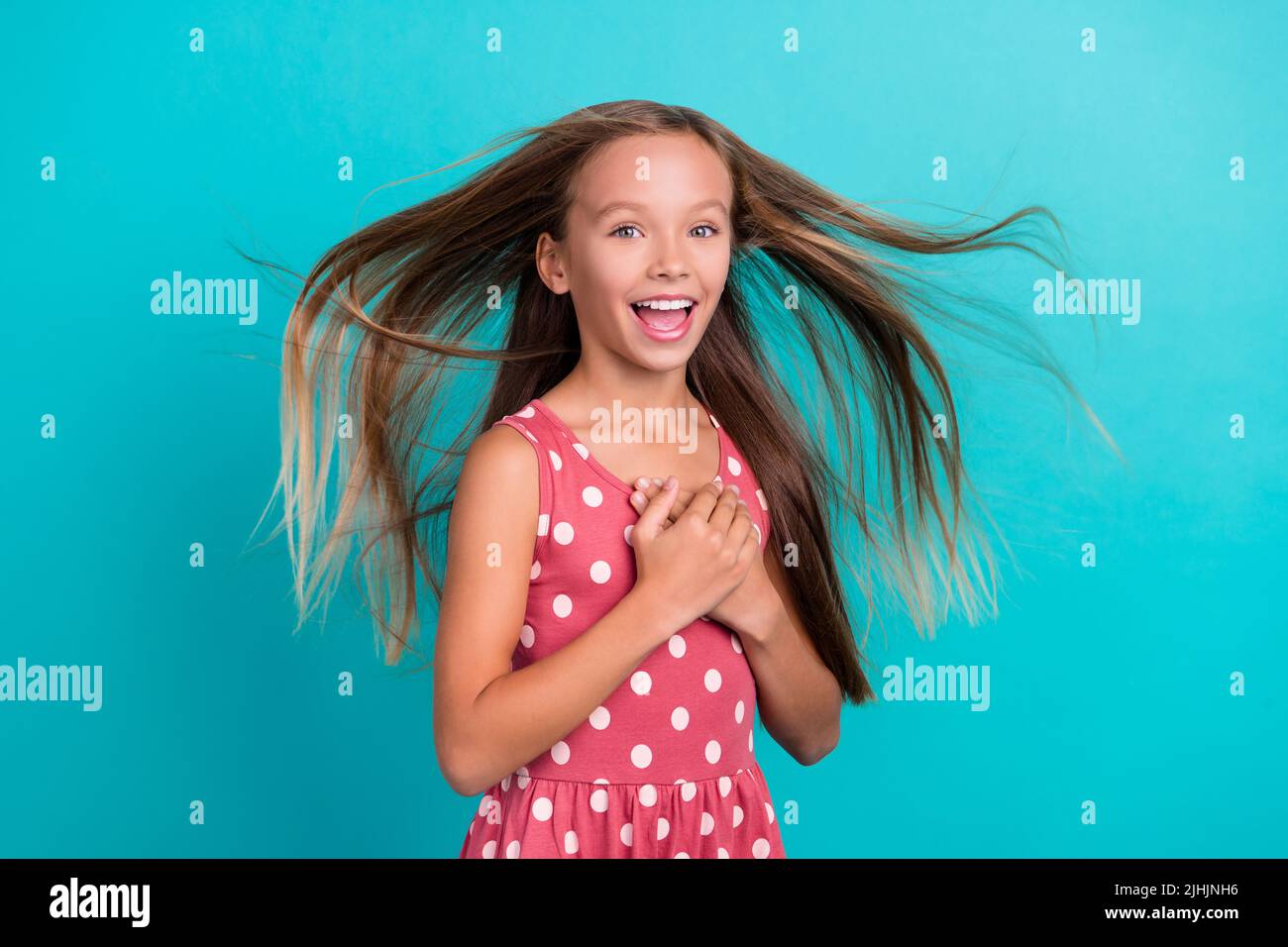 Photo of funny excited little lady dressed dotted sarafan air blowing ...