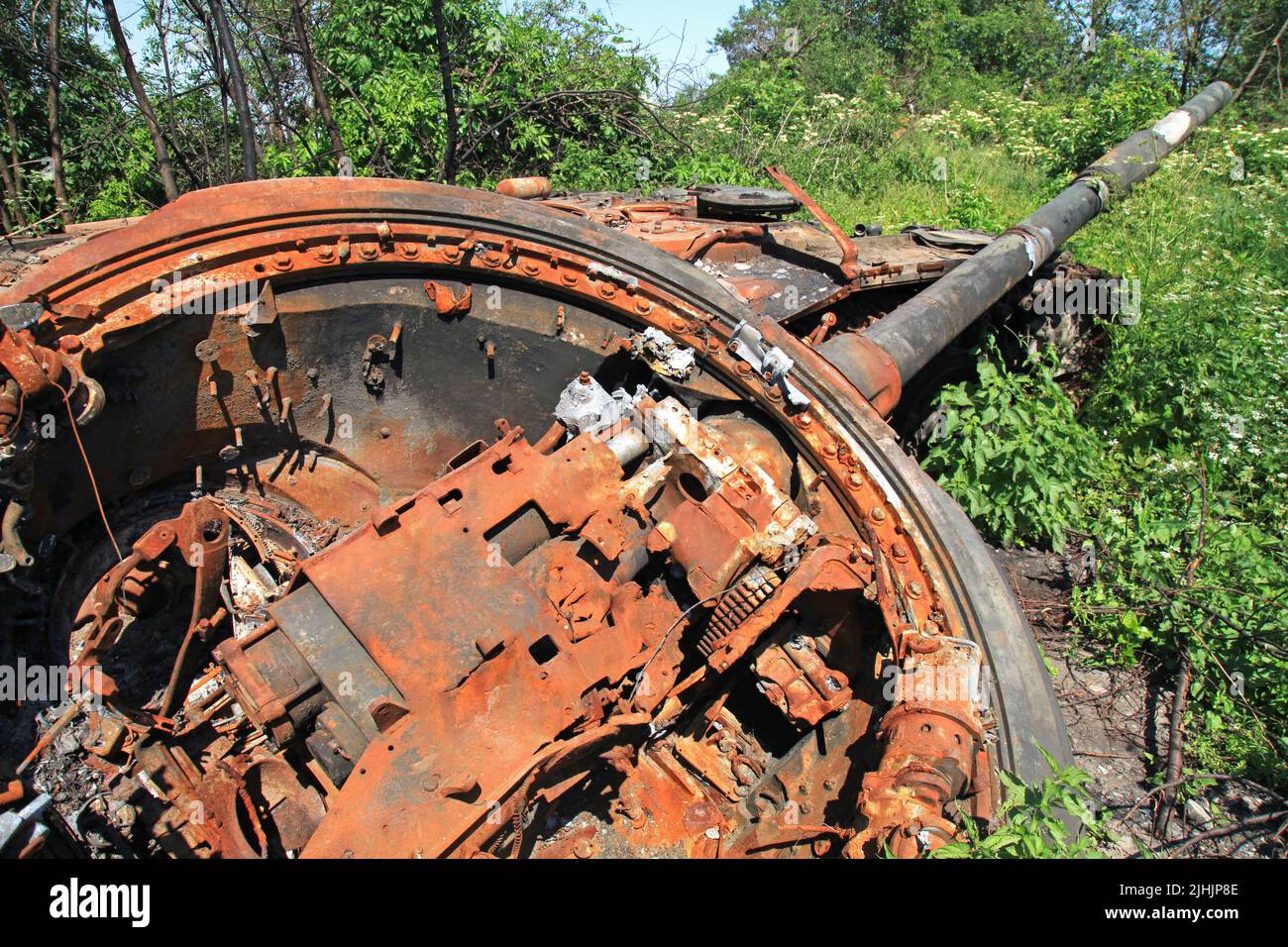 Torn off turret of a burnt and charred tank close-up. A blown up and ...