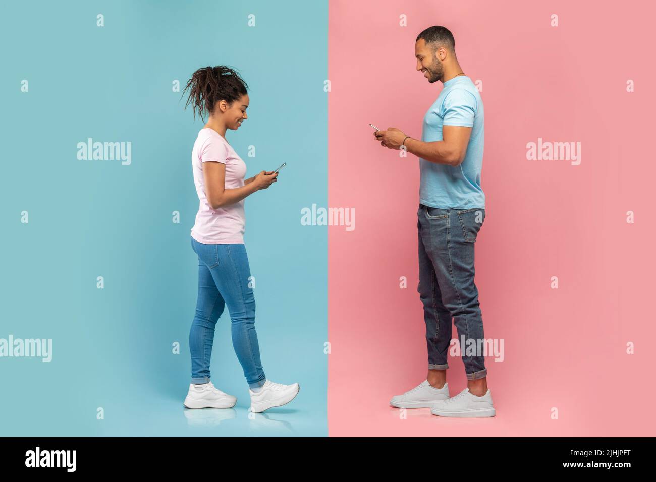 Modern technology and relationship concept. Black guy and lady using ...