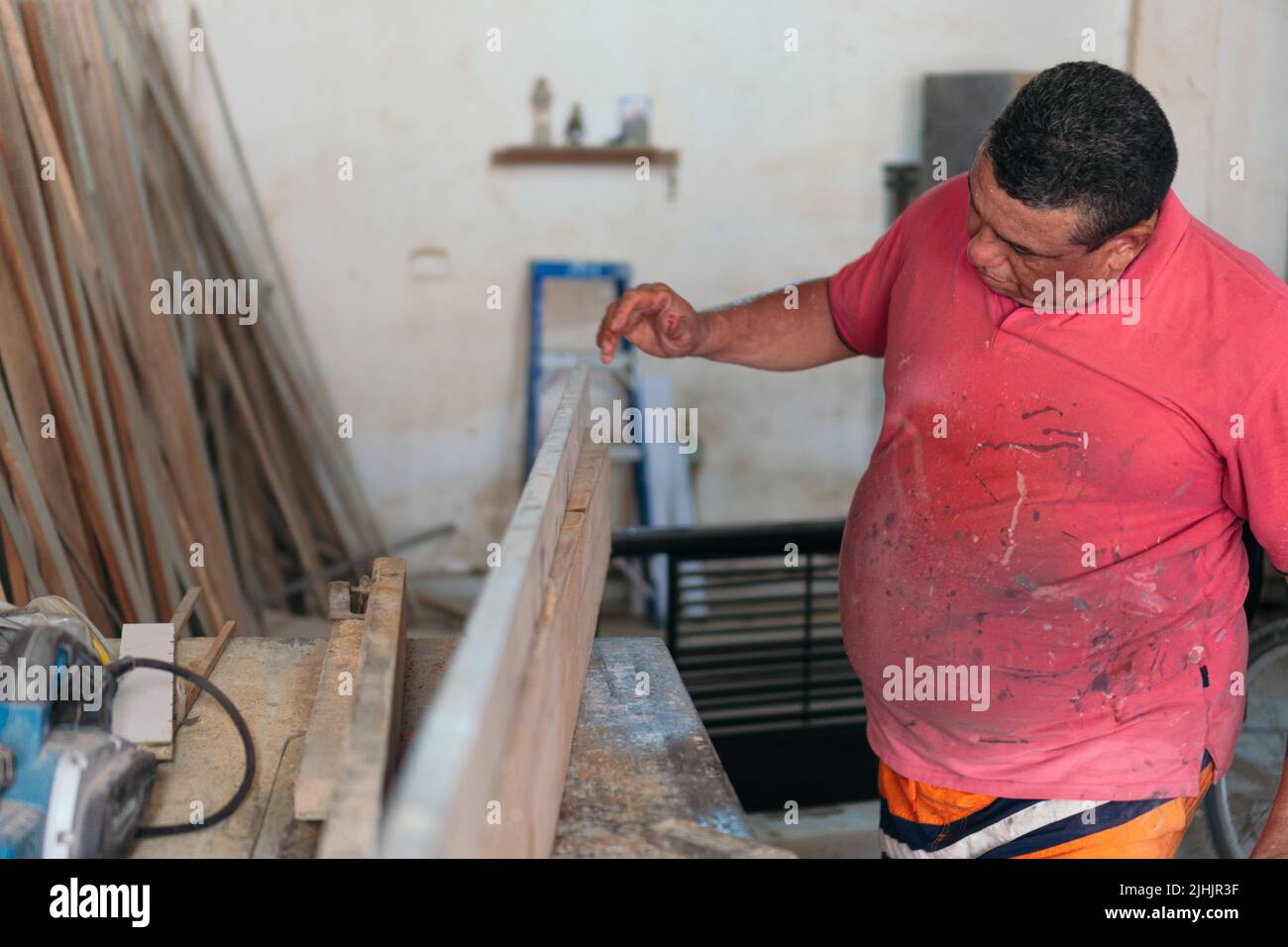 A Latino man who owns a woodworking shop at work Stock Photo - Alamy