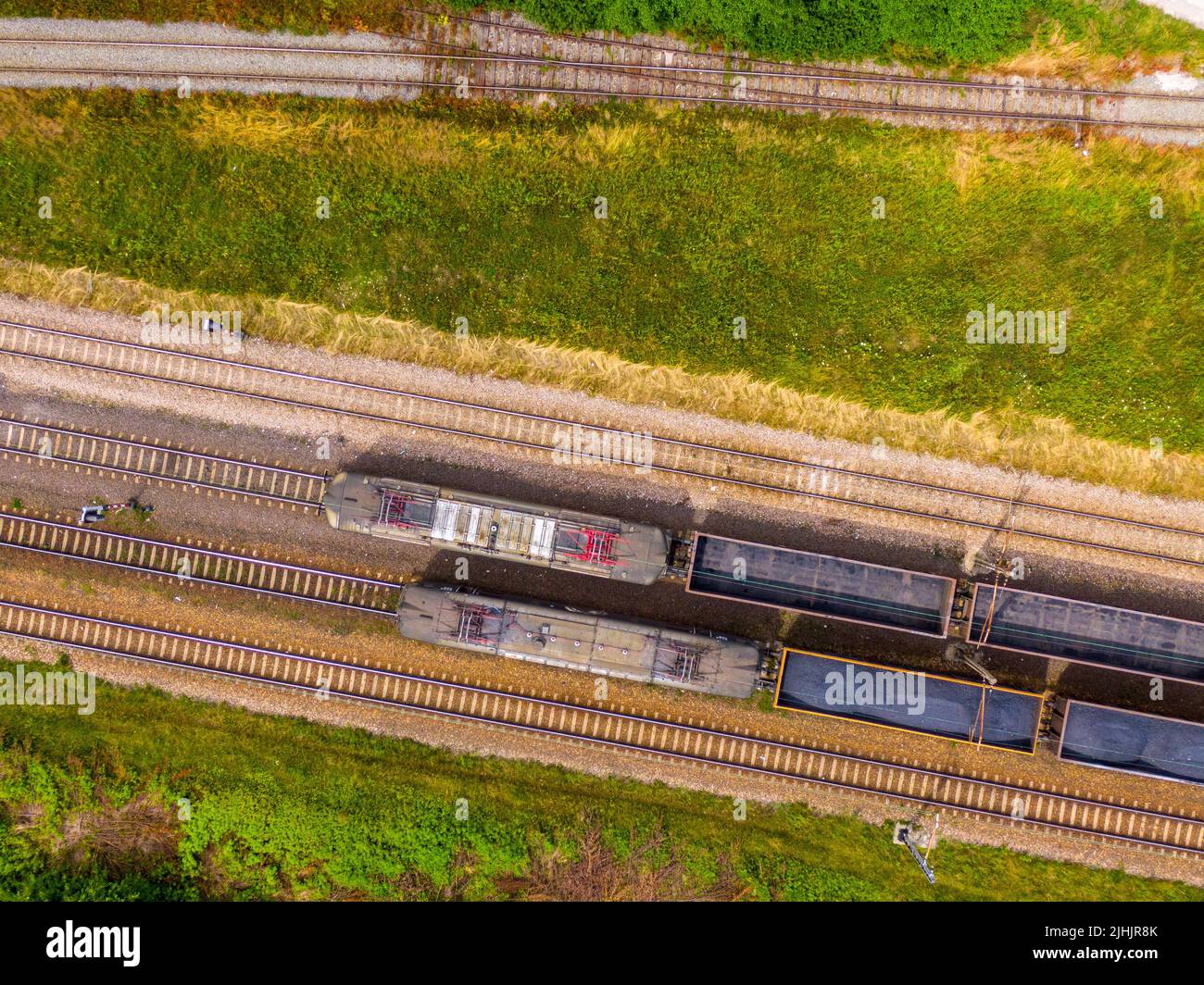 Aerial view of freight train wagons on large railway track field ...
