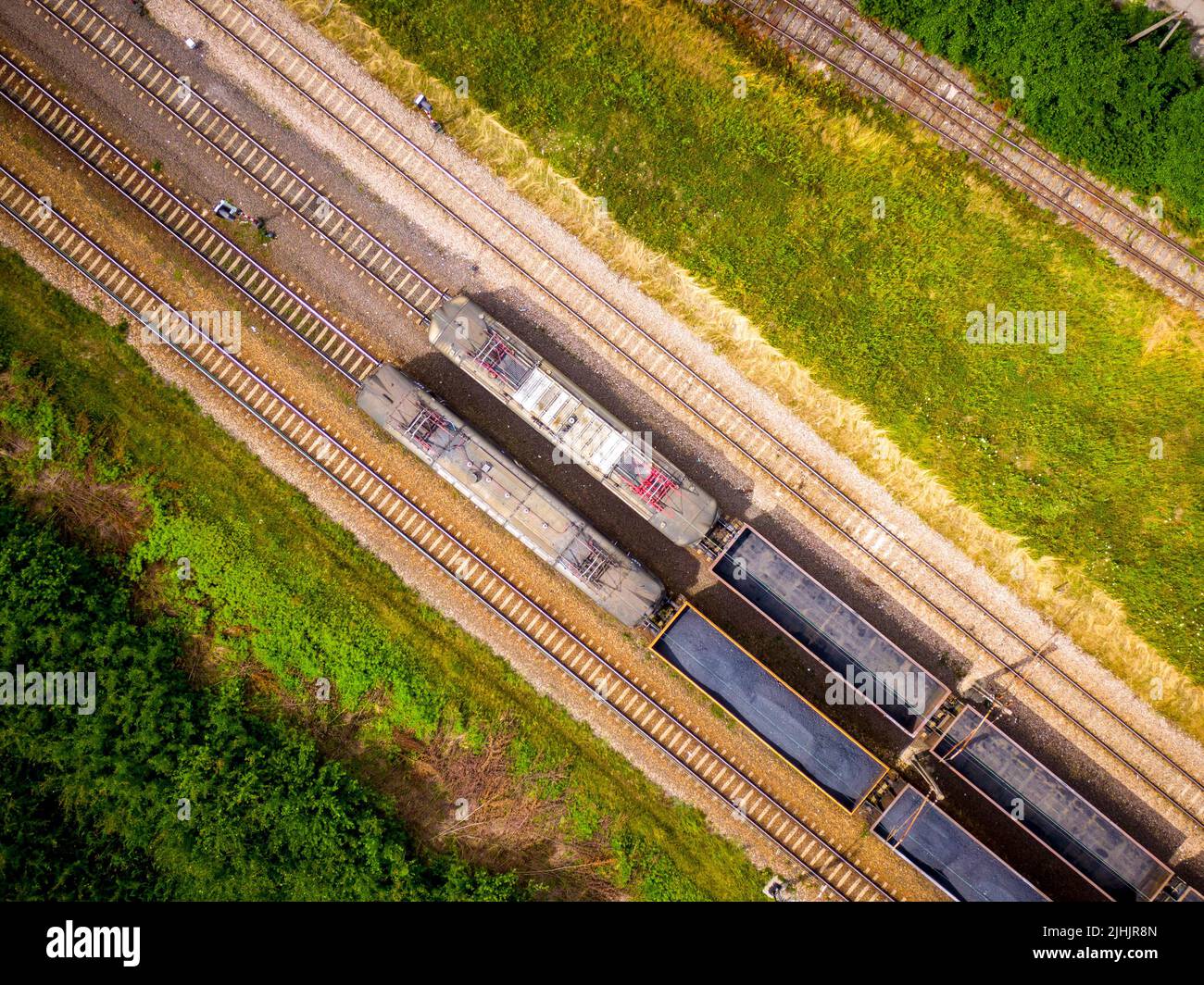 Aerial view of freight train wagons on large railway track field ...