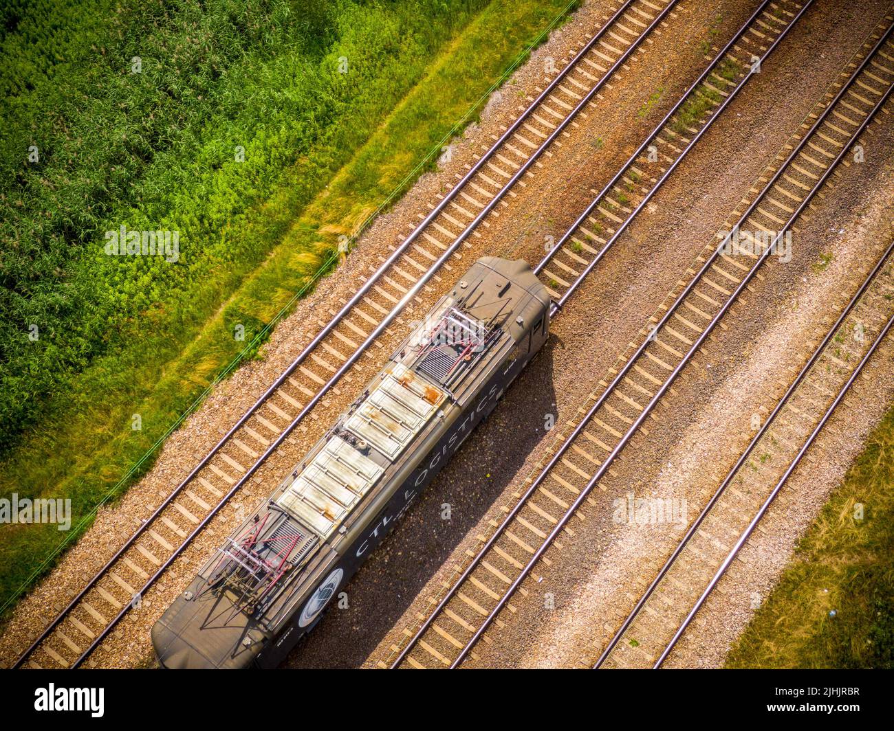 Aerial view of freight train wagons on large railway track field ...