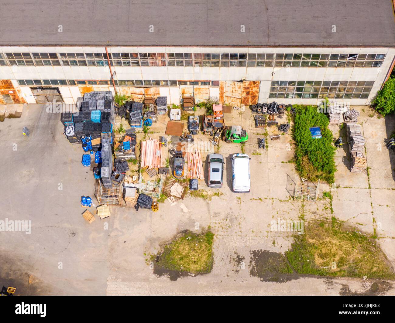 Aerial view of storage with rows of discarded broken cars. Recycling of ...