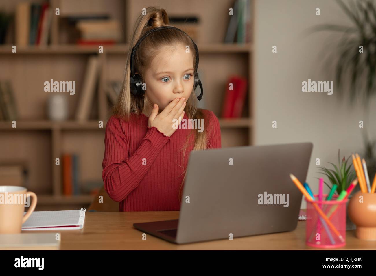 Shocked Kid Girl Looking At Laptop Computer Learning Online Indoors ...