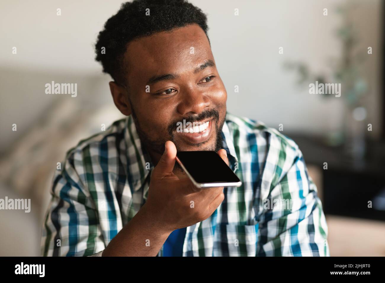 Happy Black Male Talking On Phone Using Voice Search Indoor Stock Photo ...