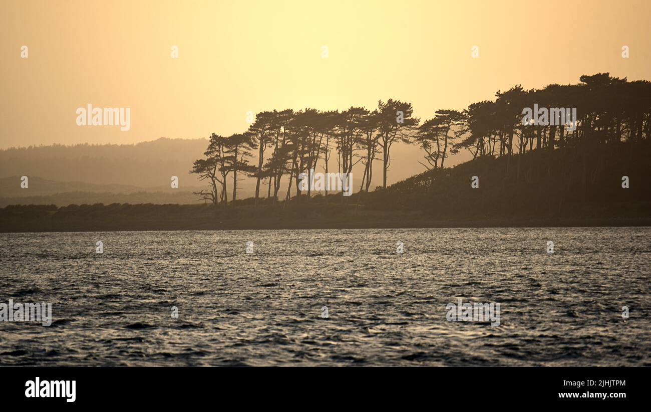 Orange skies over water at the end of a beautiful summer's day in ...